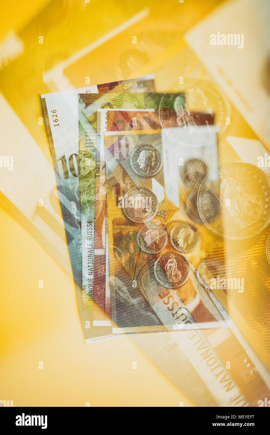 Swiss cash paper bills and coins lie on a yellow background Stock Photo ...