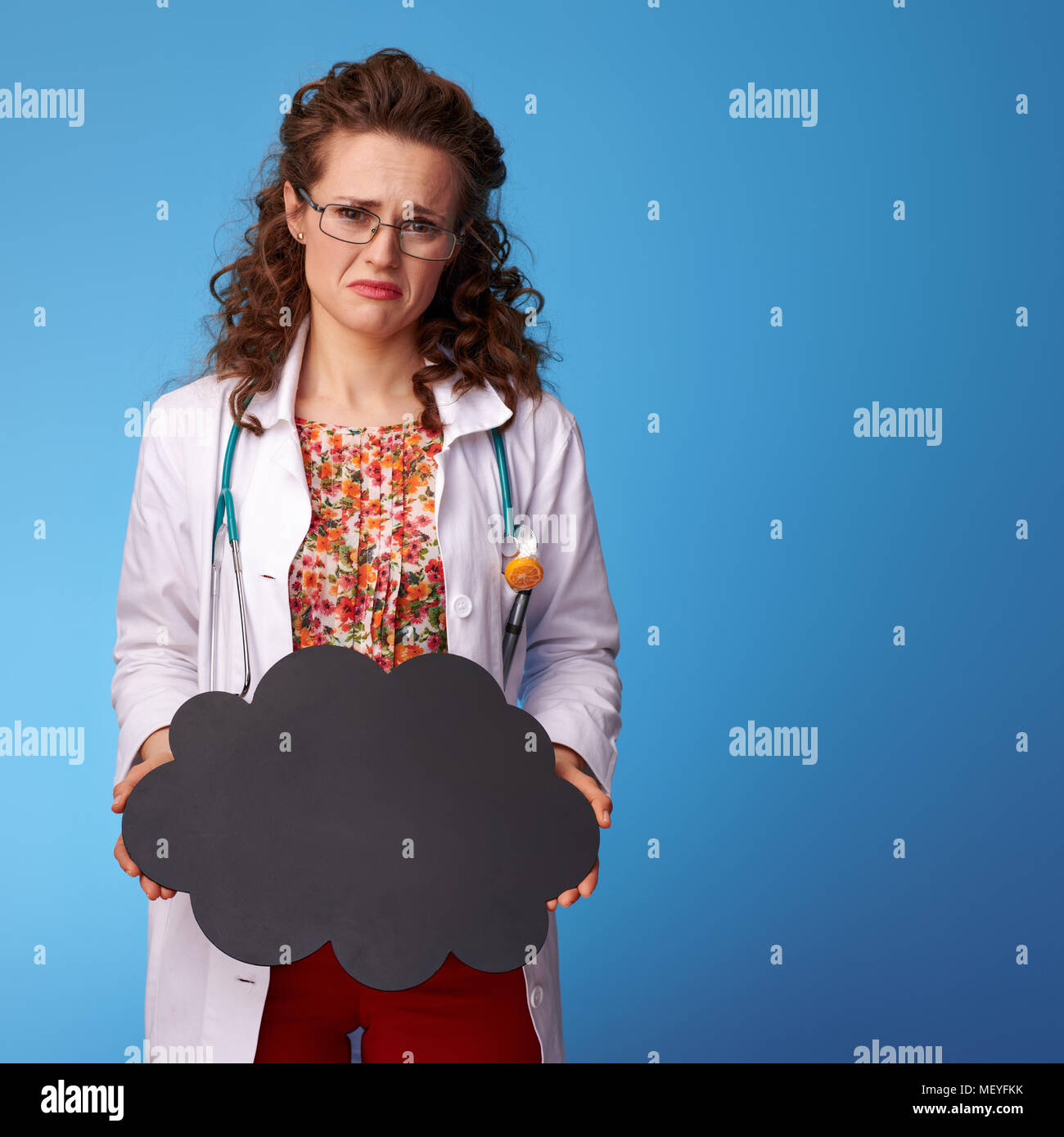 sad paediatrist woman in white medical robe showing black cloud on blue ...