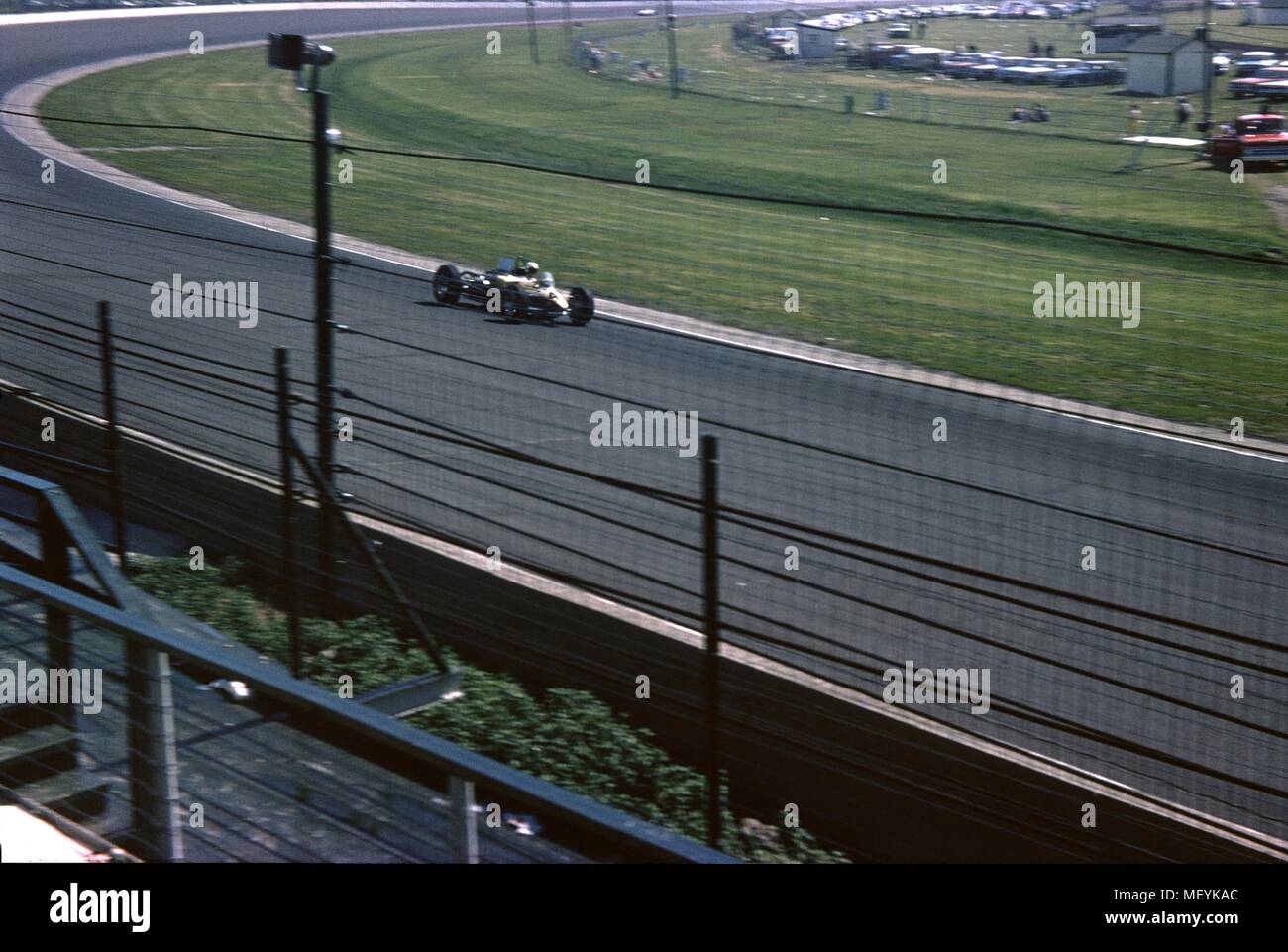 Race cars and spectators are visible at the Indianapolis 500 automobile ...
