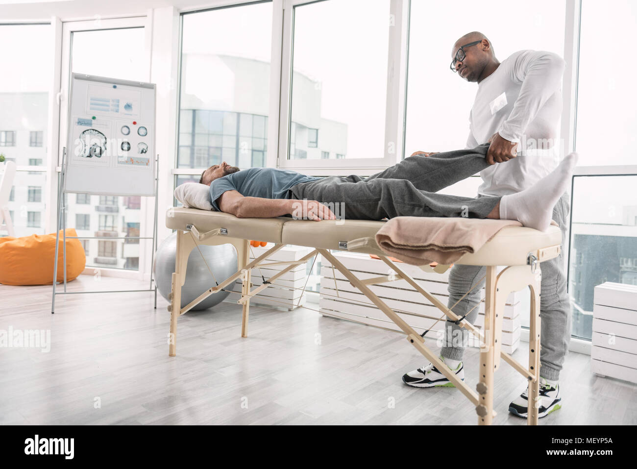 Skillful male doctor doing the therapy Stock Photo - Alamy