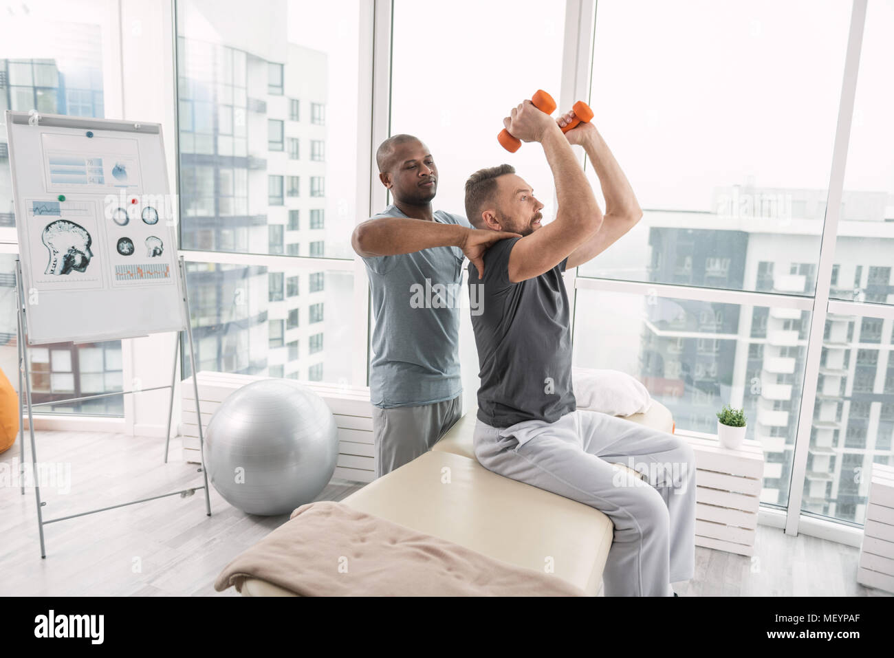 Pleasant skillful man monitoring his patient Stock Photo - Alamy
