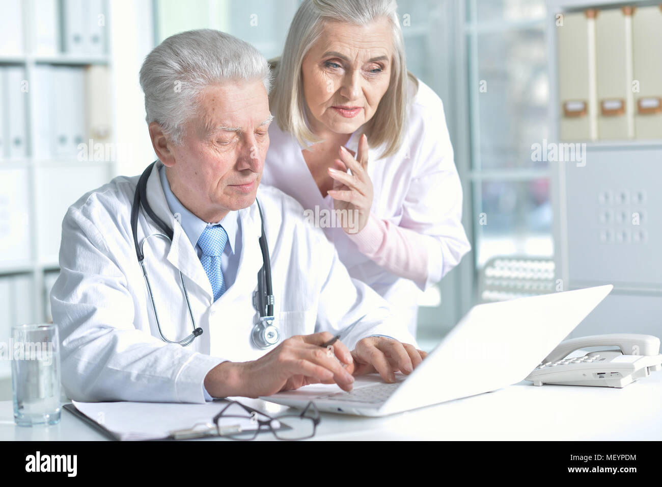 Male and female doctors working Stock Photo - Alamy