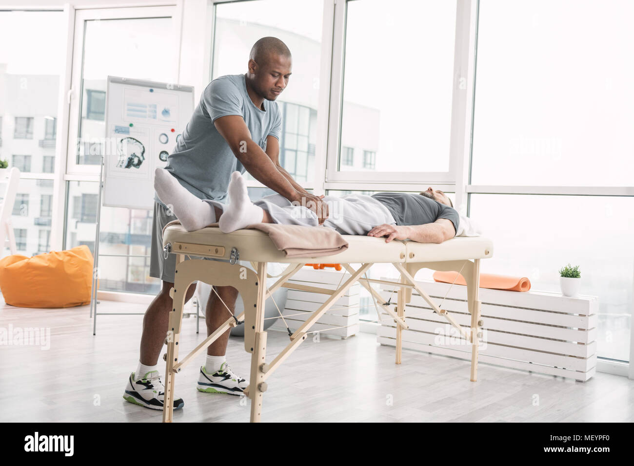 Smart nice man doing the therapy procedures Stock Photo - Alamy