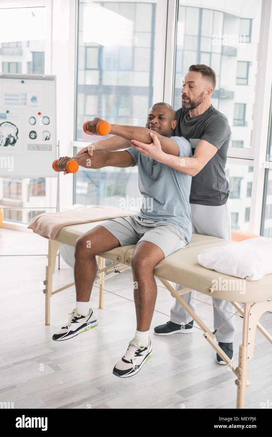 Pleasant young man lifting his hand Stock Photo - Alamy