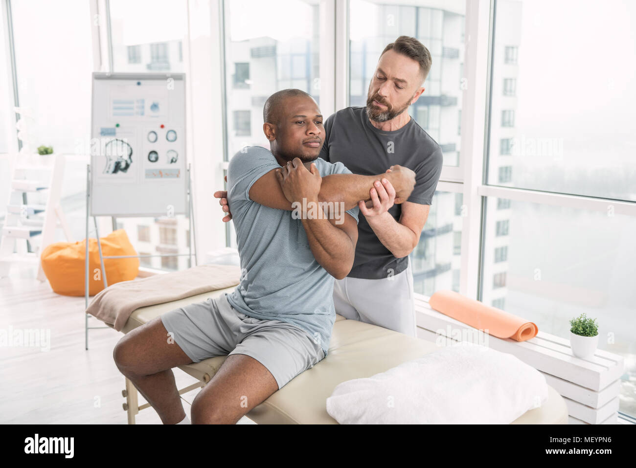 Pleasant good looking man moving his body Stock Photo - Alamy