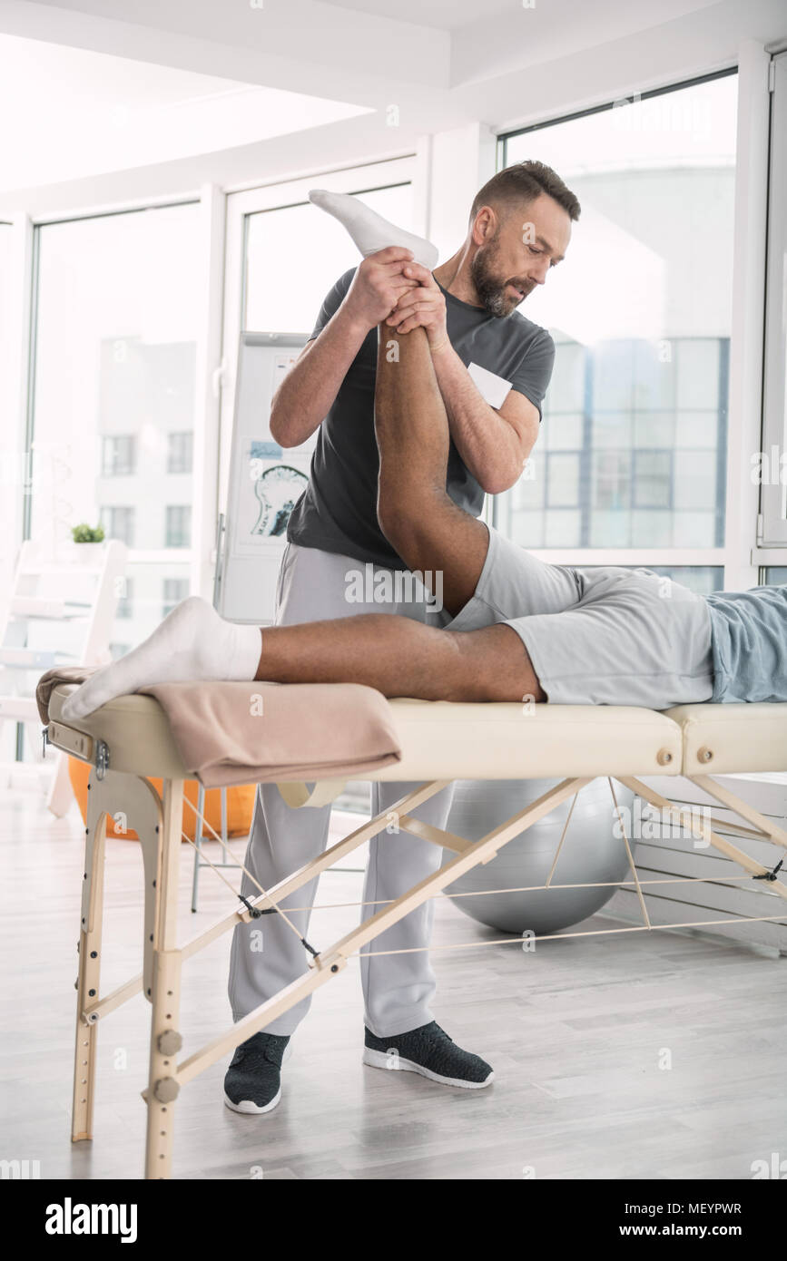 Nice experienced doctor working Stock Photo - Alamy