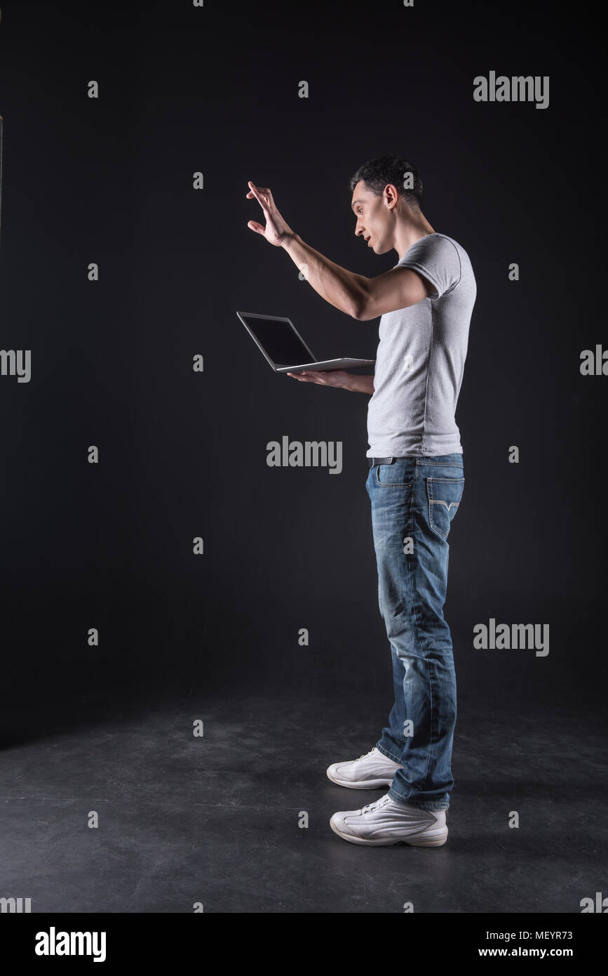 Intelligent young man installing the settings Stock Photo - Alamy