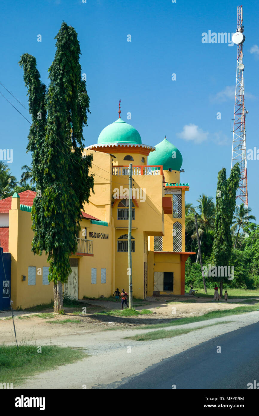 The exterior of a small Muslim mosque with domes and children outside ...