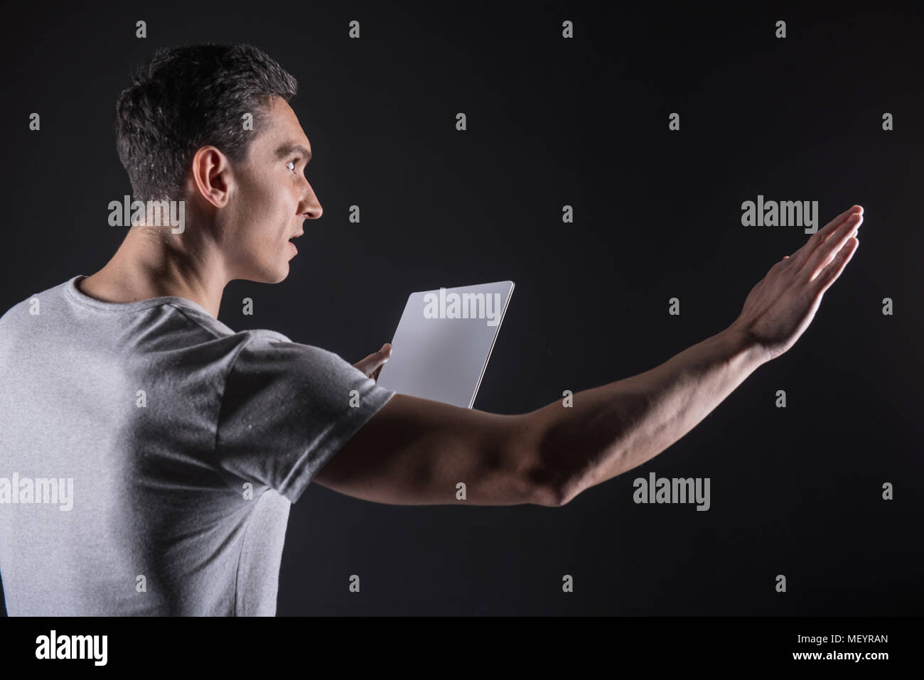 Intelligent brunette man stretching out his hand Stock Photo - Alamy