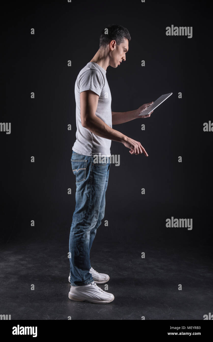 Serious young man pressing a button Stock Photo - Alamy