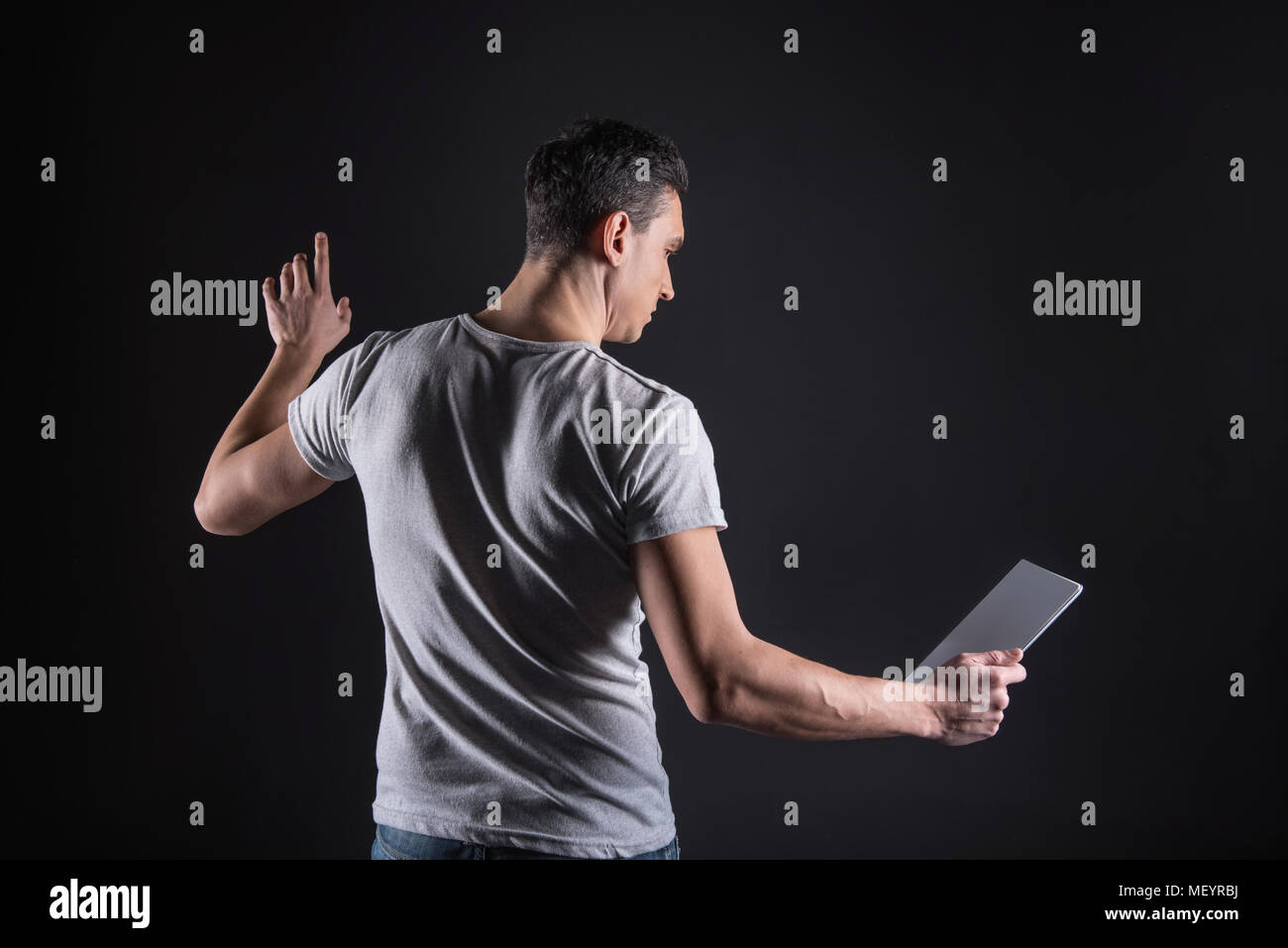 Smart brunette man looking at the tablet screen Stock Photo - Alamy