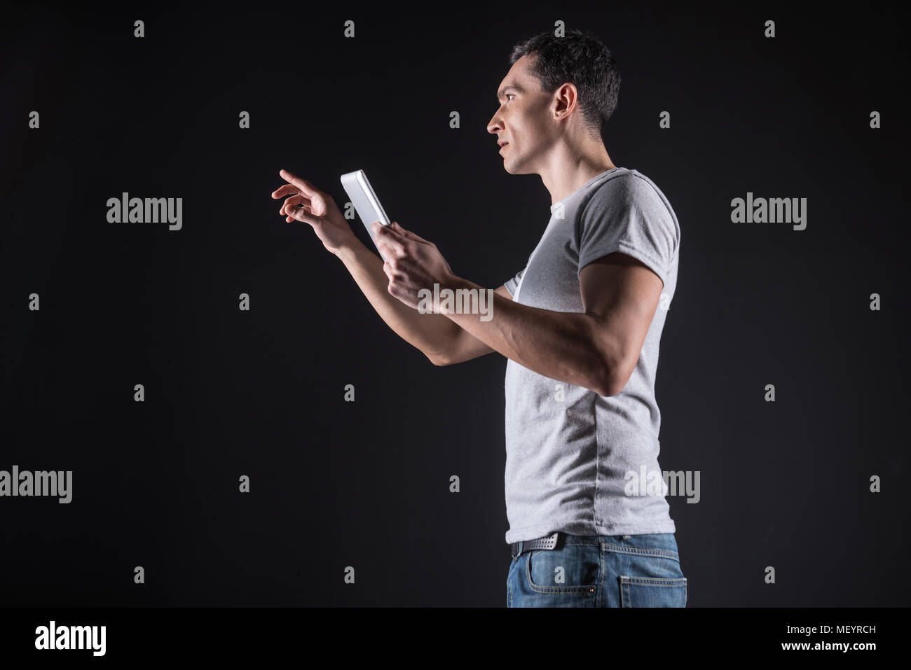 Serious handsome man looking at the digital screen Stock Photo - Alamy