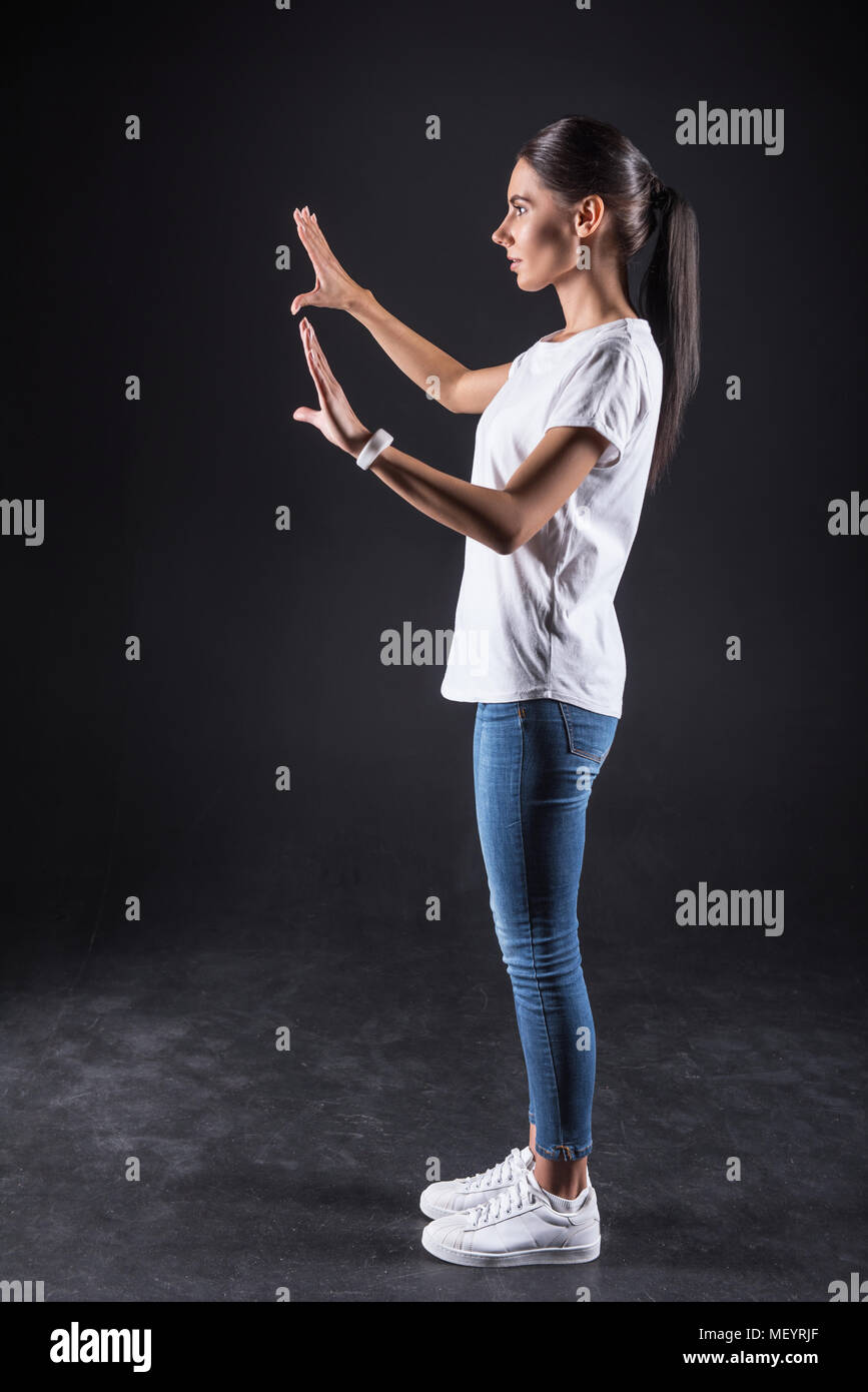 Joyful attractive woman standing in front of the computer screen Stock ...