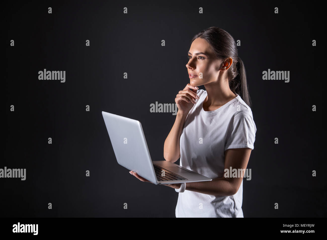 Nice young woman being thoughtful Stock Photo - Alamy
