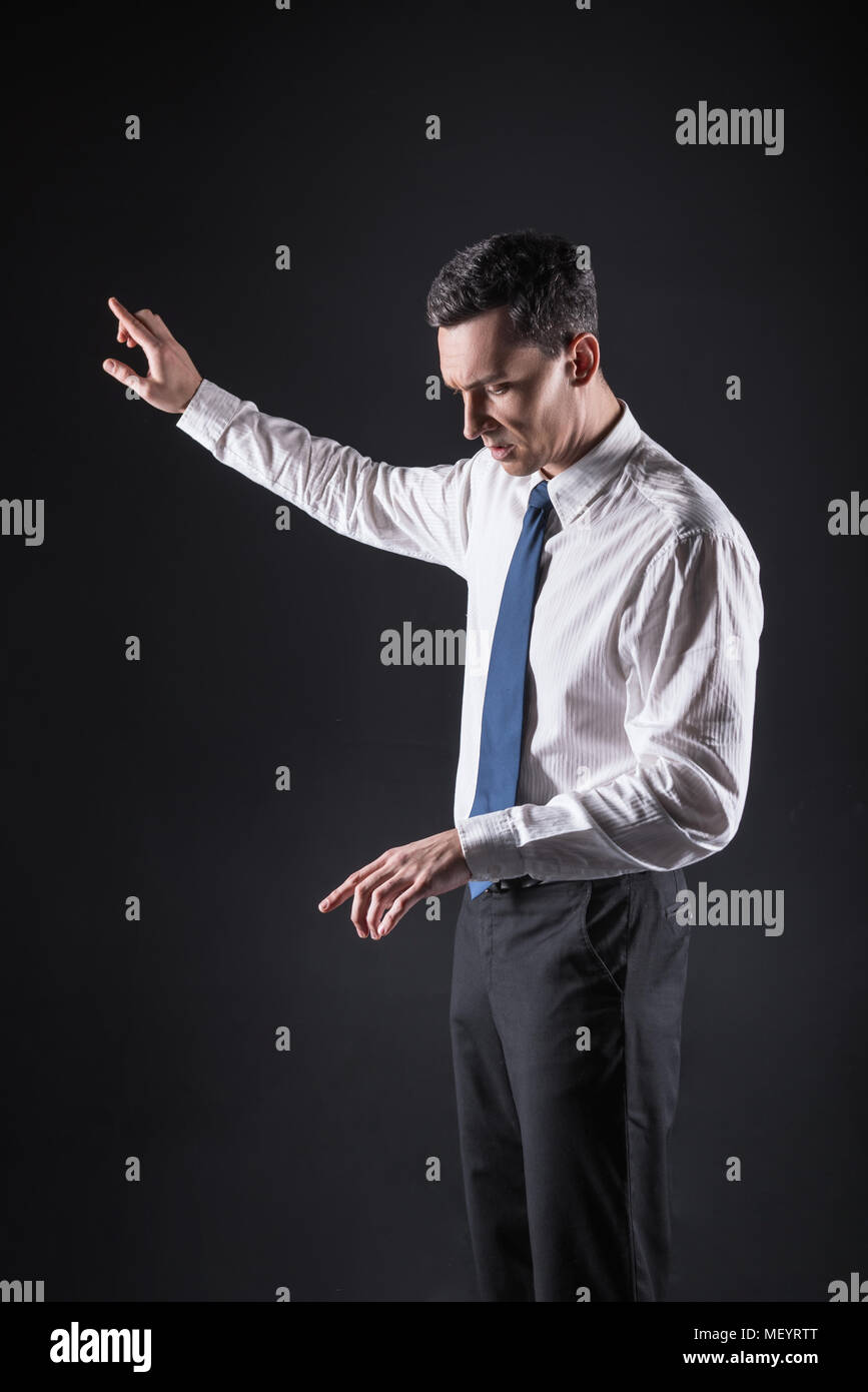 Smart adult man looking down Stock Photo - Alamy