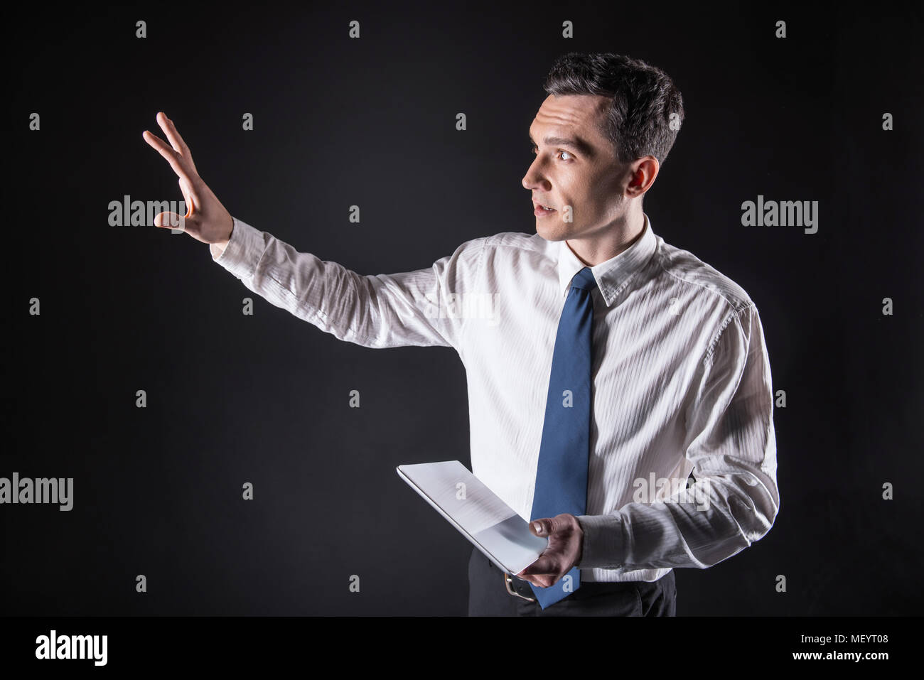 Smart young man using progressive technologies Stock Photo - Alamy