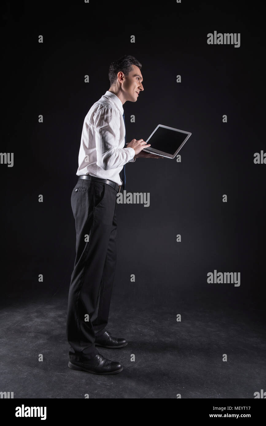 Joyful smart man using technological devices Stock Photo - Alamy