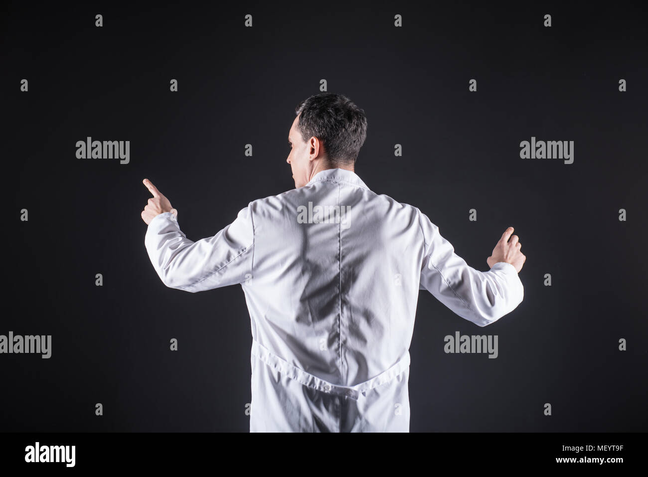 Smart male scientist using computer panel Stock Photo - Alamy