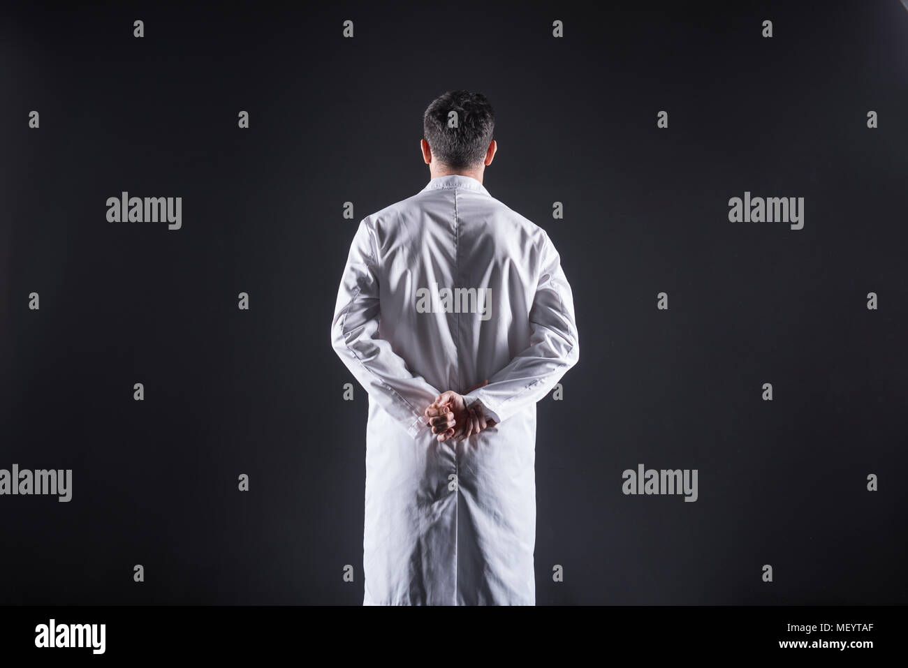 Smart confident man holding his hands behind his back Stock Photo - Alamy