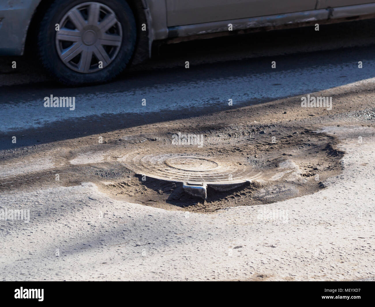 Dangerous pit on the road in Russian town Stock Photo - Alamy