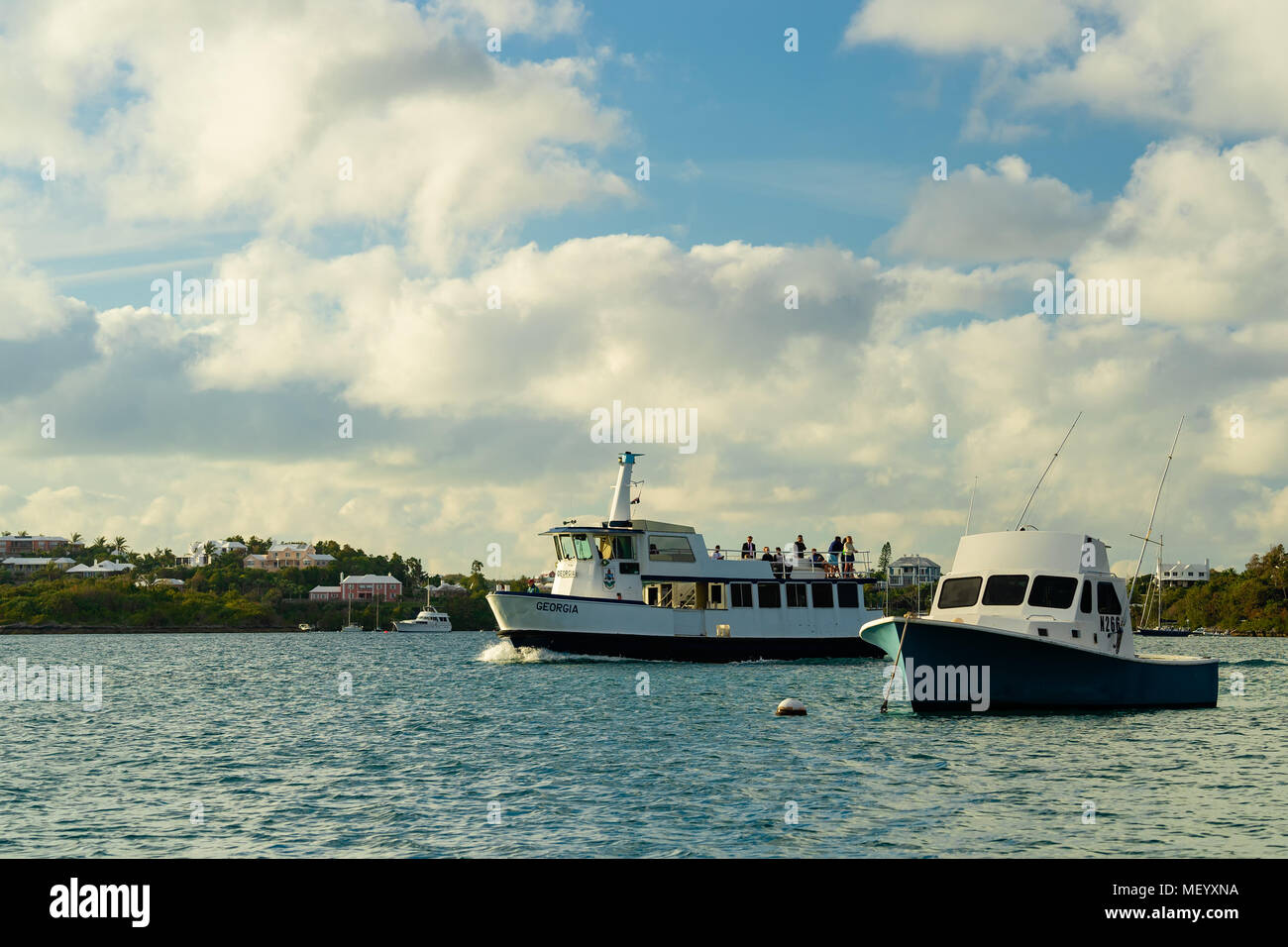 Bermuda ferry travelling down Hamilton Harbour with a moored fishing ...