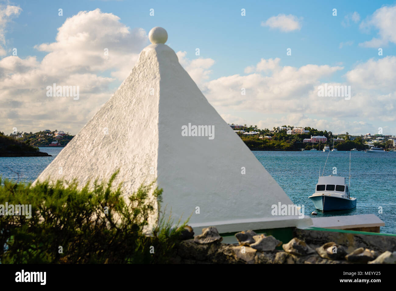 Traditional Bermudian architecture overlooking fishing boat moored in ...