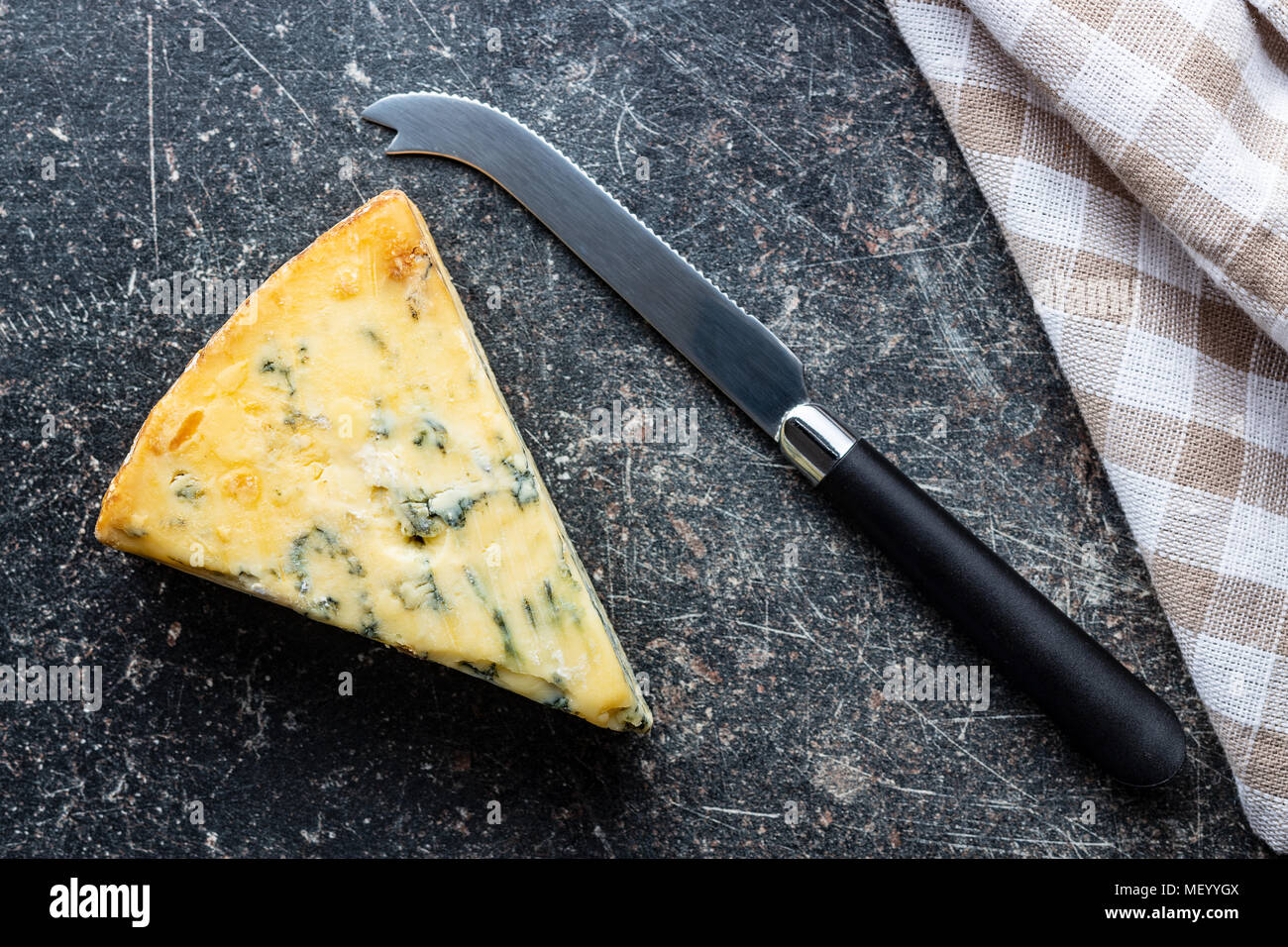 Tasty blue cheese on old kitchen table Stock Photo - Alamy
