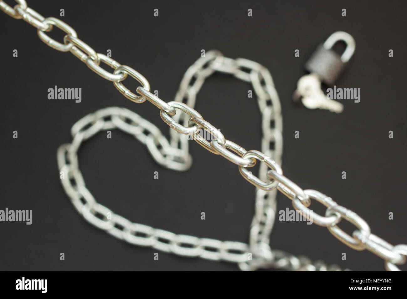 Silver chain on black background, concept strong love Stock Photo - Alamy