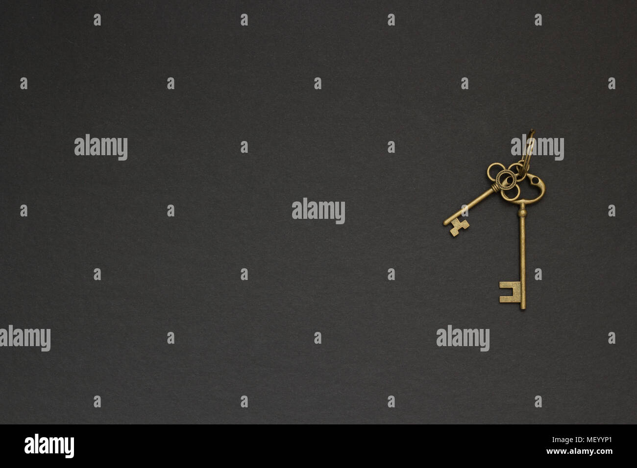 Old retro big key on black background Stock Photo - Alamy