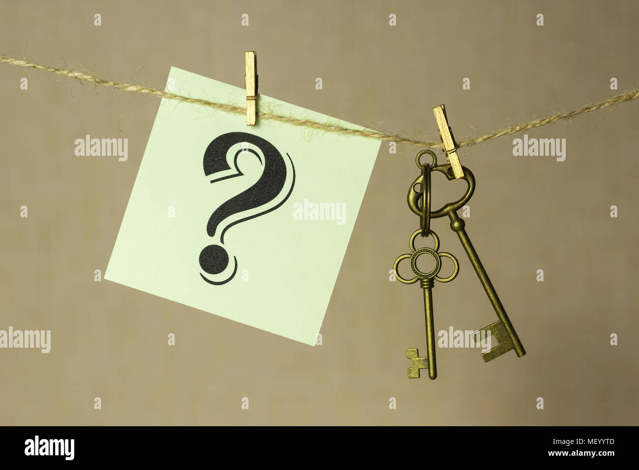 Vintage key hanging on a rope on a gold background, next sticker with ...