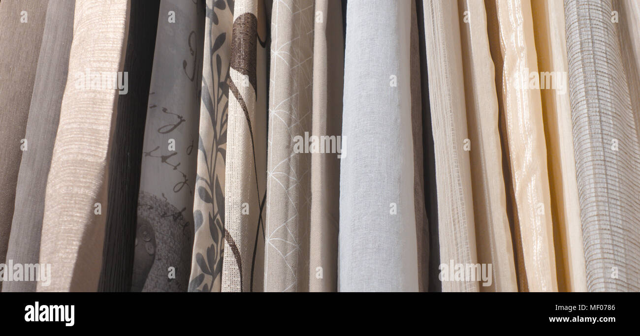 Displayed curtains samples hanging in the shop Stock Photo - Alamy