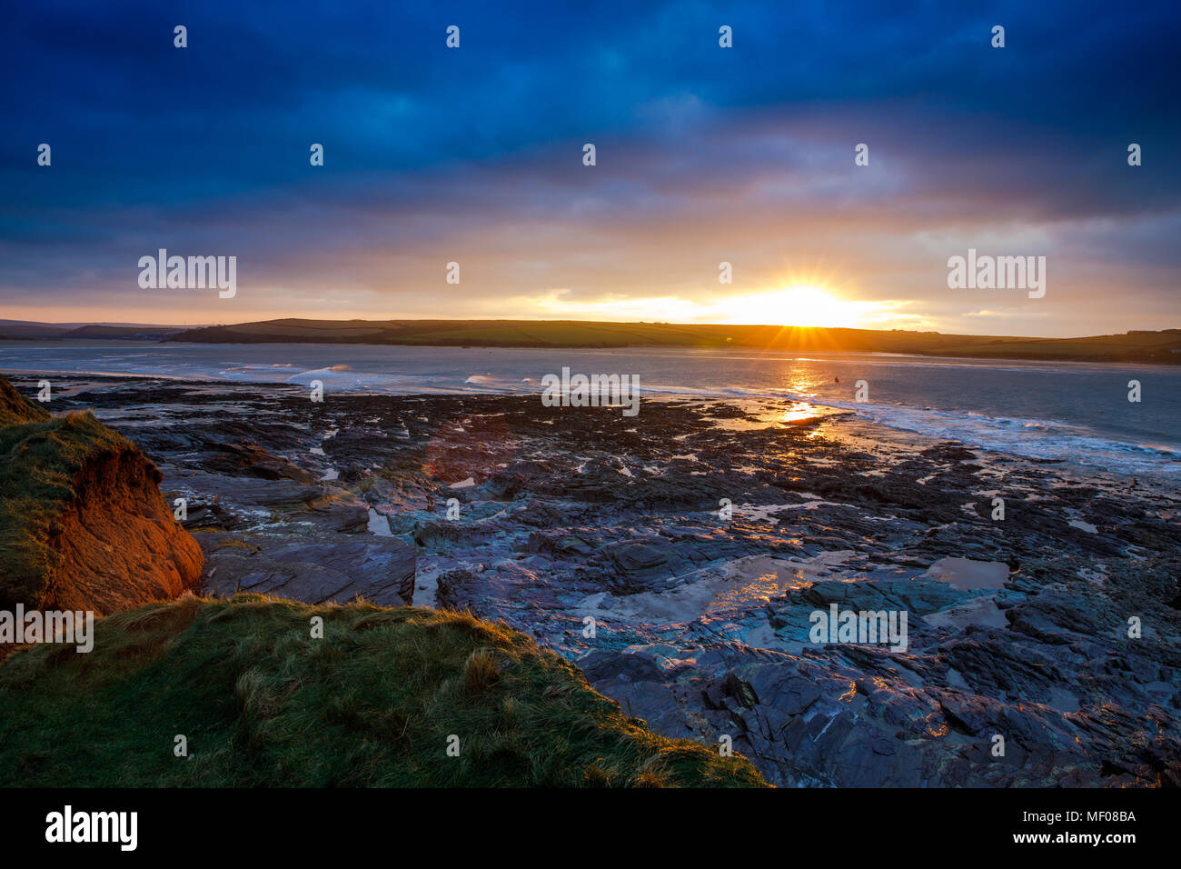 The sun setting over Daymer Bay in Cornwall (UK) at low tide Stock ...