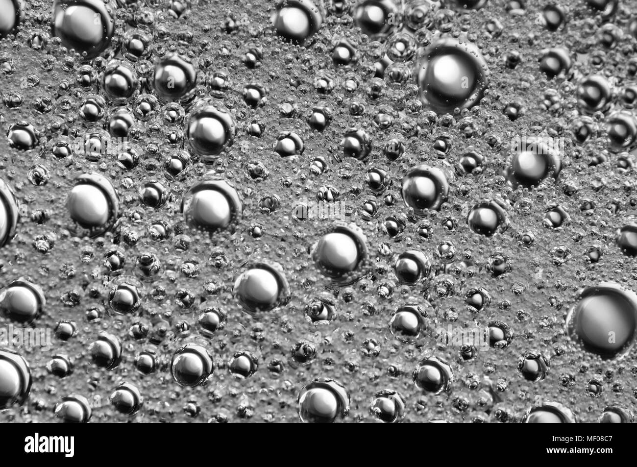 Black-and-white background with big and small grey bubbles inside a ...