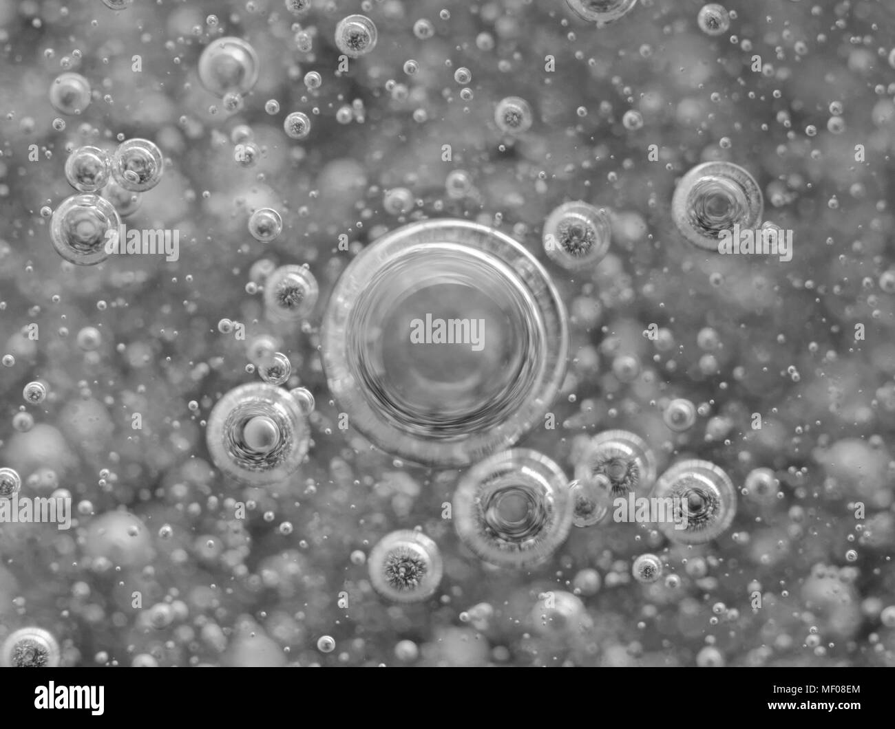 Black-and-white background with big and small grey bubbles inside a ...