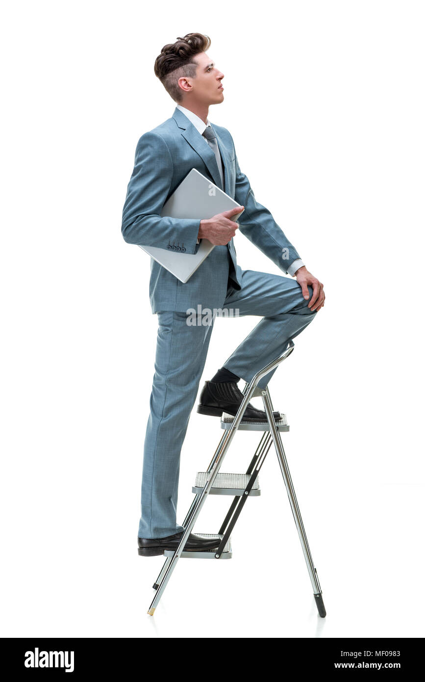 Young handsome businessman climbing up the success ladder looking up ...
