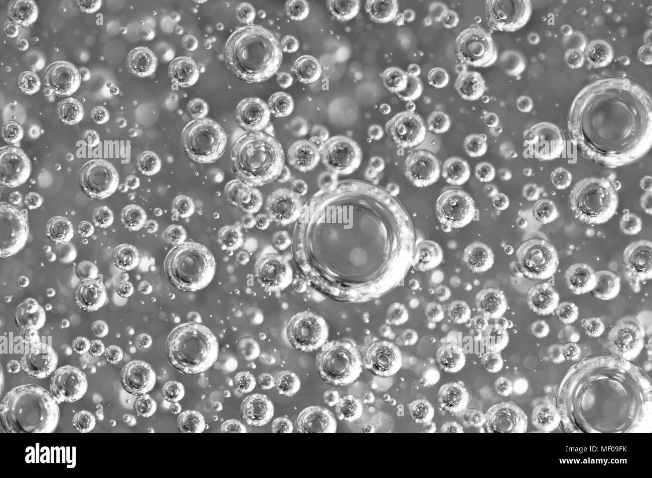 Black-and-white background with big and small grey bubbles inside a ...