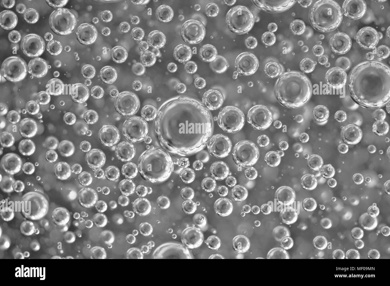 Black-and-white background with big and small grey bubbles inside a ...