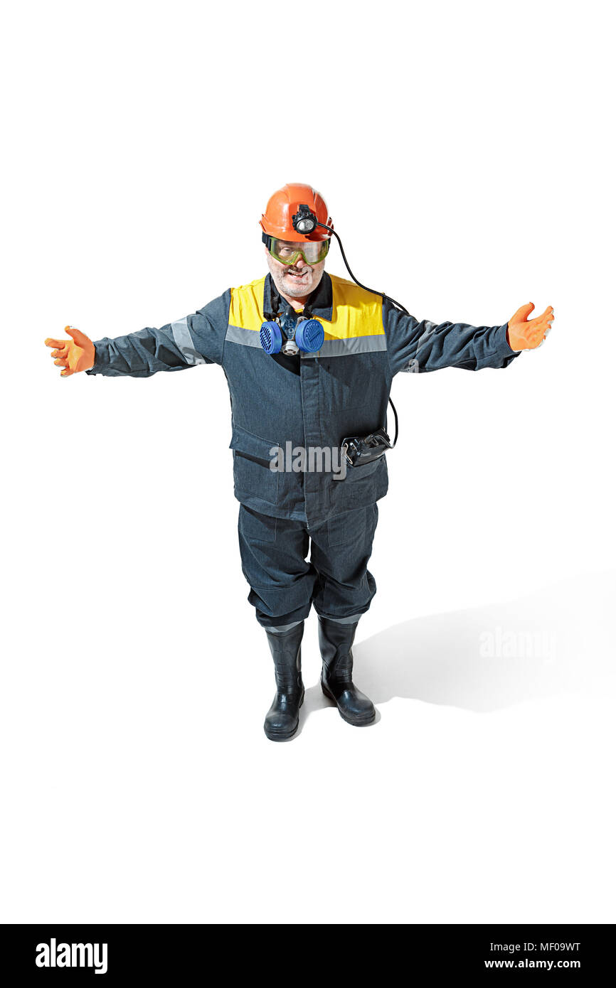 The studio shot of senior bearded male miner standing at the camera on ...