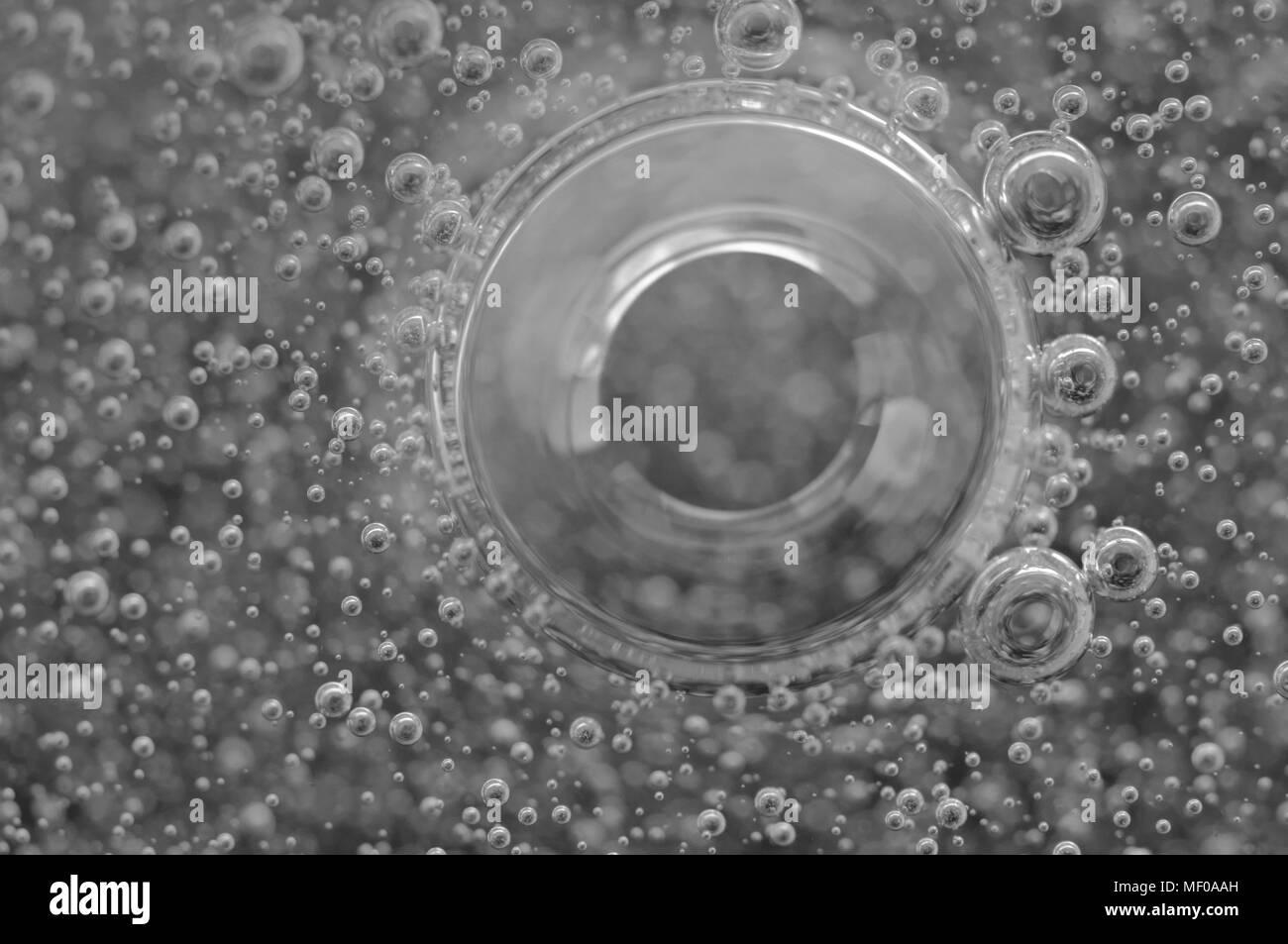 Black-and-white background with big and small grey bubbles inside a ...