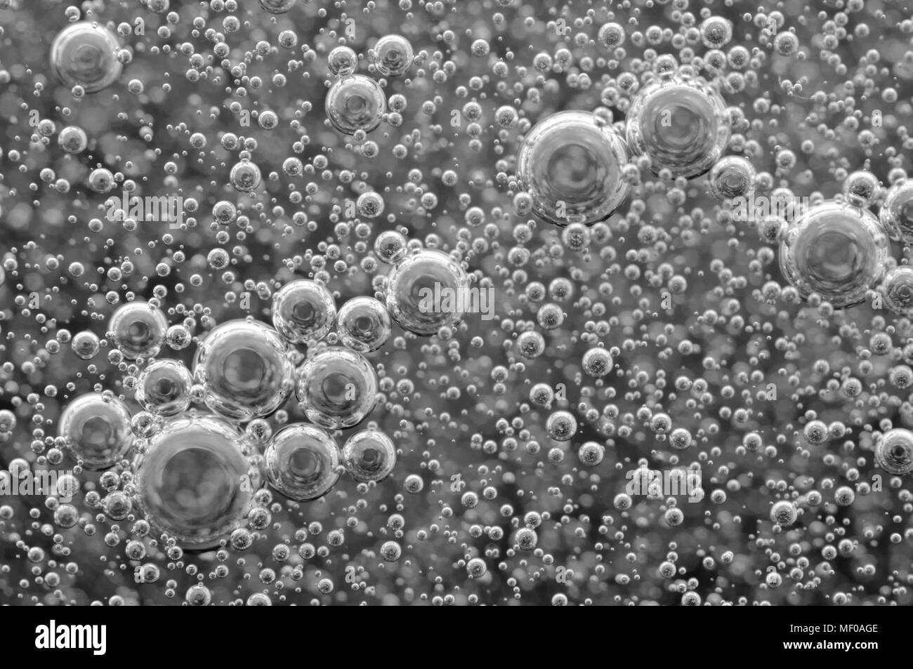 Black-and-white background with big and small grey bubbles inside a ...