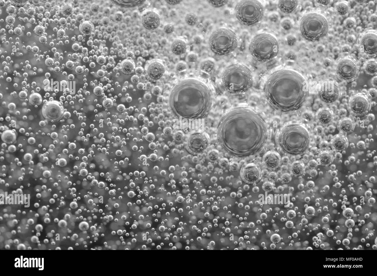 Black-and-white background with big and small grey bubbles inside a ...