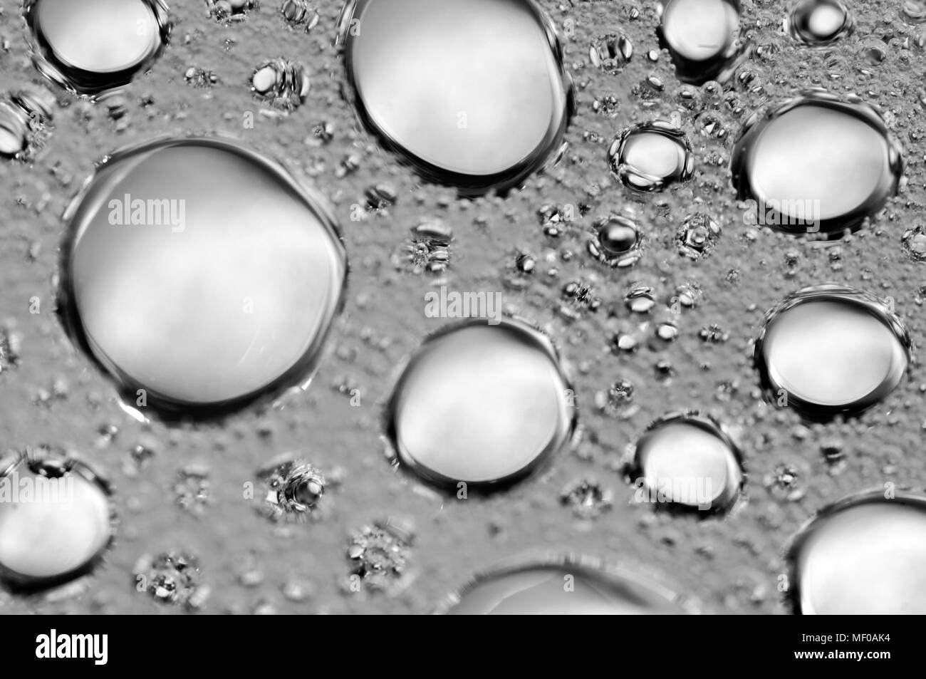 Black-and-white background with big and small grey bubbles inside a ...