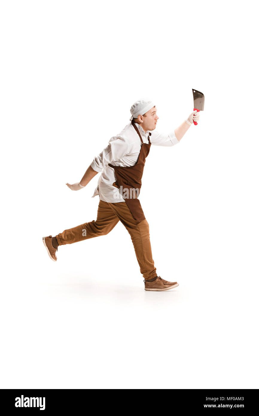 Smiling butcher posing with a cleaver isolated on white background ...