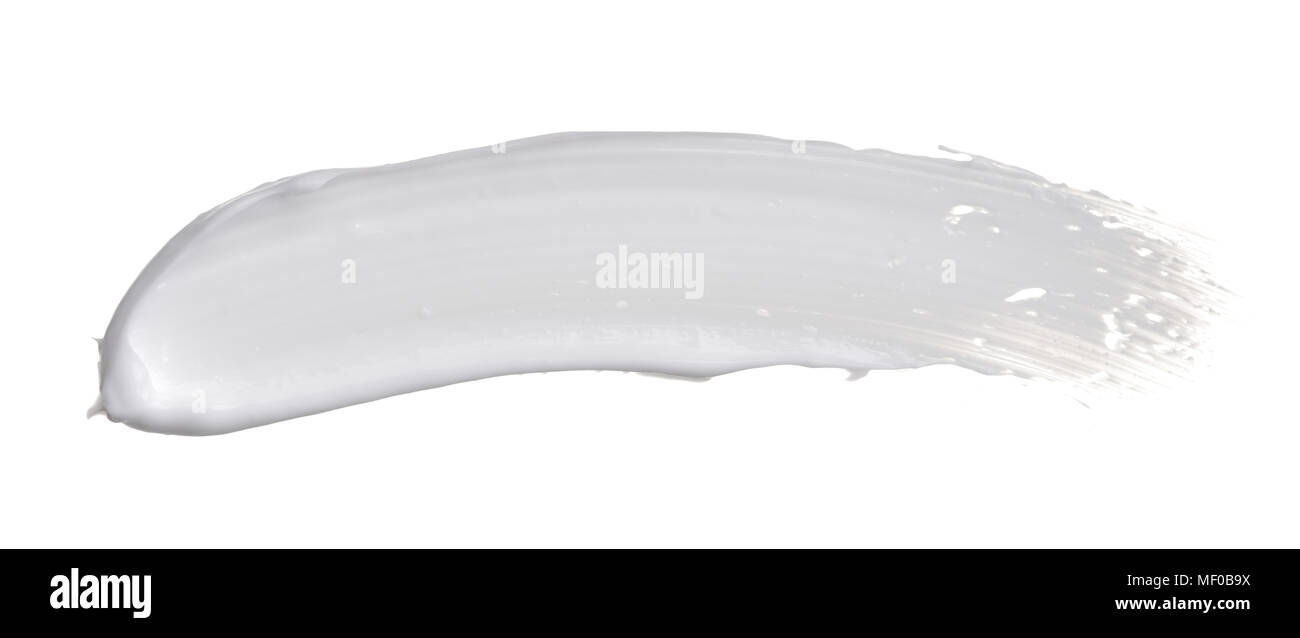 White ?reamy texture isolated on white background. Smear of face cream ...
