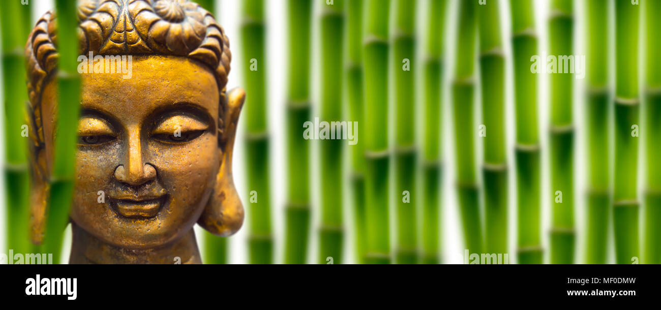 buddha head on bamboo background Stock Photo - Alamy