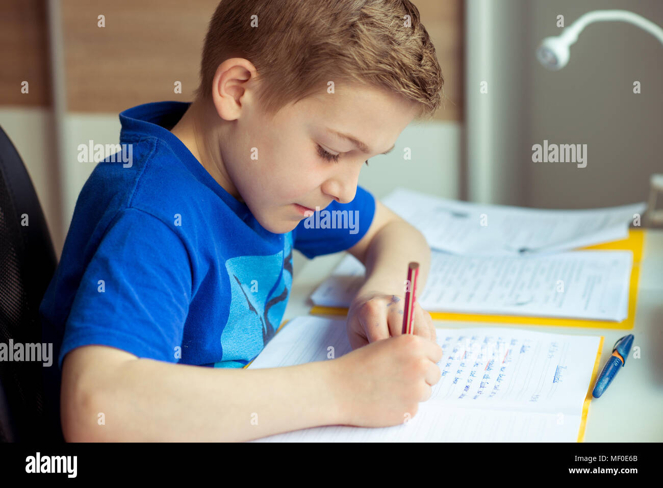 Intelligent boy makes homework at desk in his room Stock Photo - Alamy