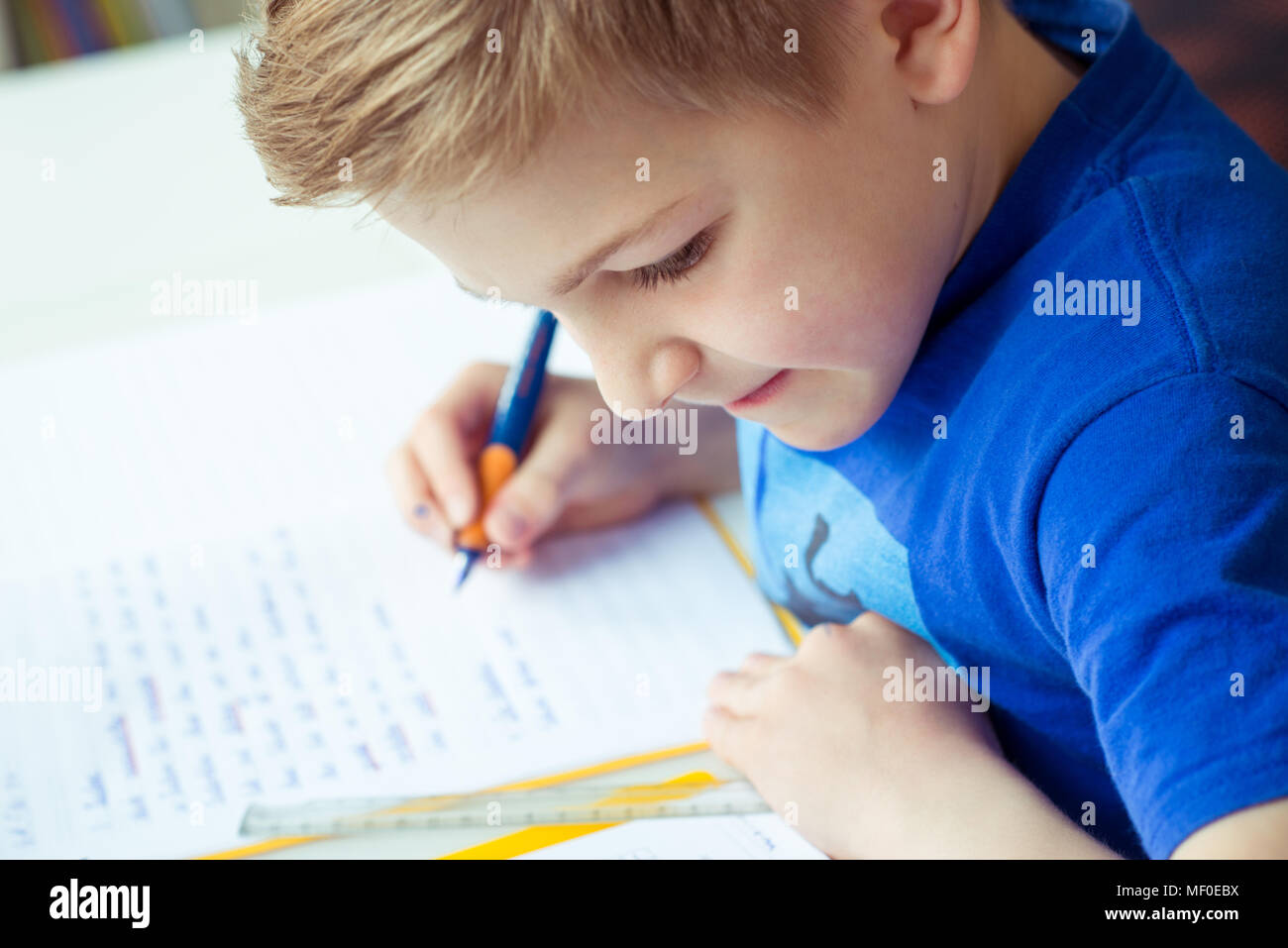 Intelligent boy makes homework at desk in his room Stock Photo - Alamy