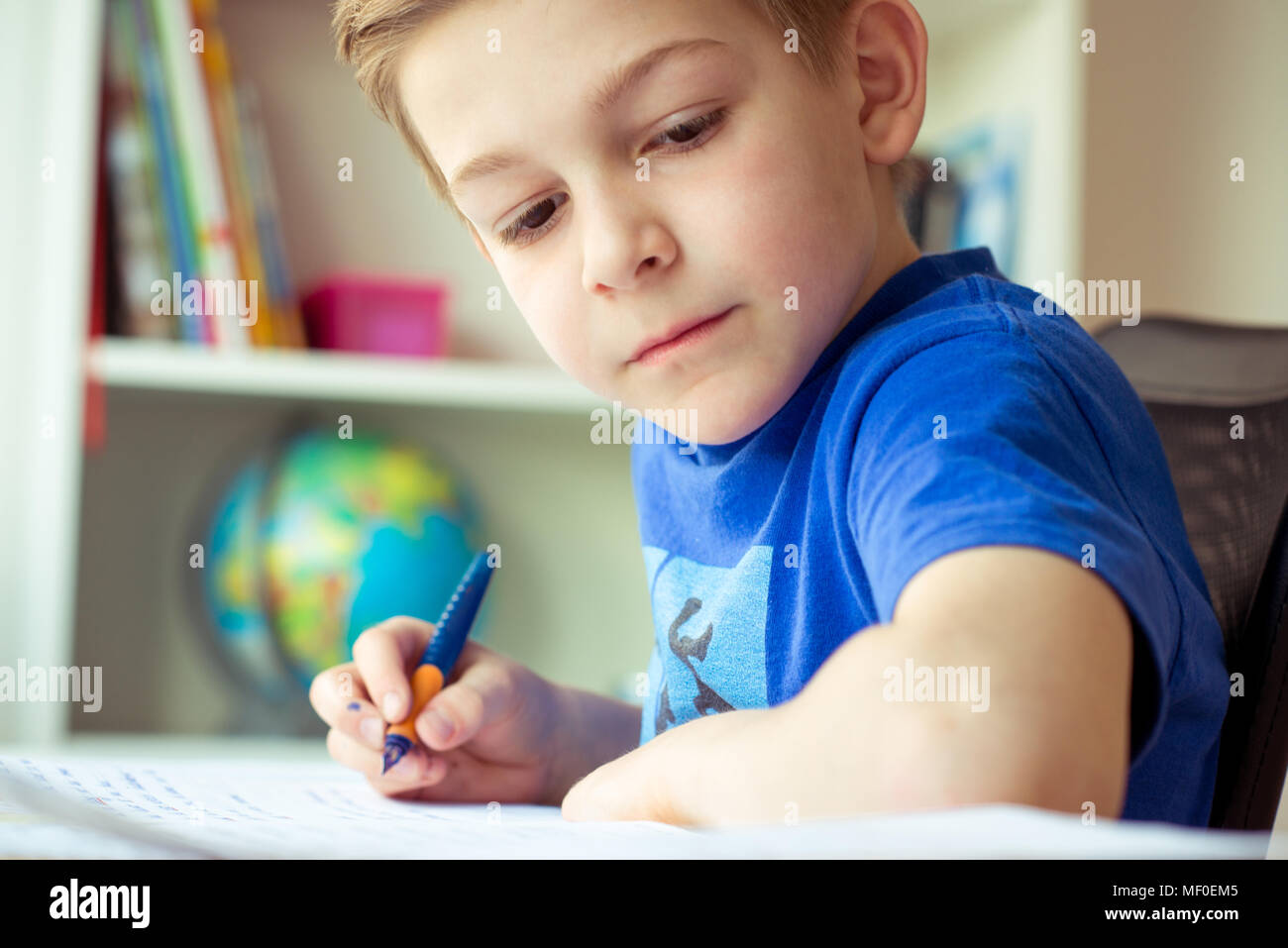 Intelligent boy makes homework at desk in his room Stock Photo - Alamy