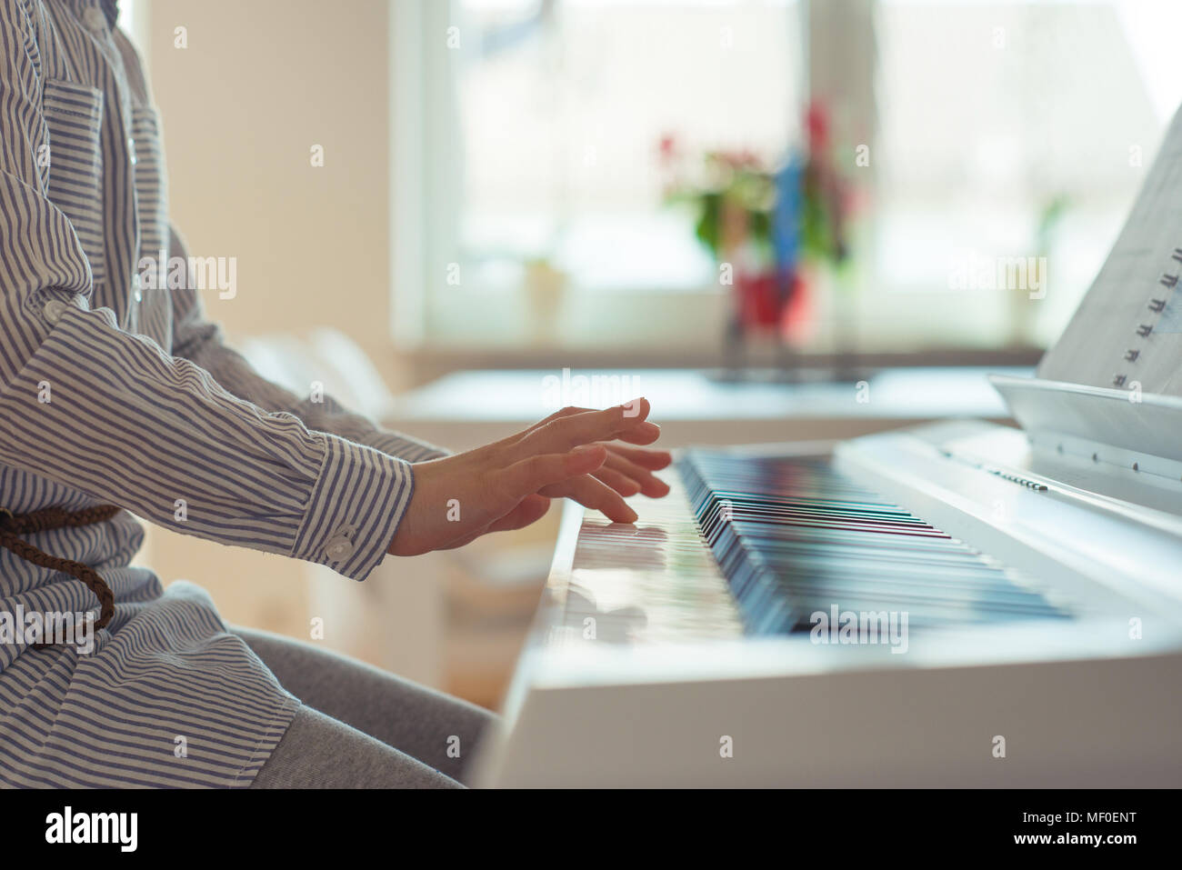 Cute little girl has training course with piano Stock Photo - Alamy