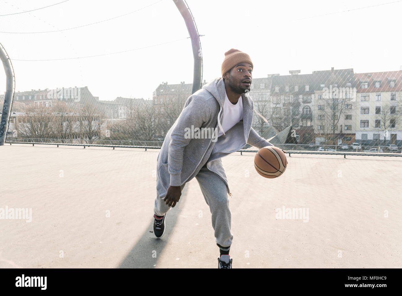 Basketball player in action on court Stock Photo - Alamy